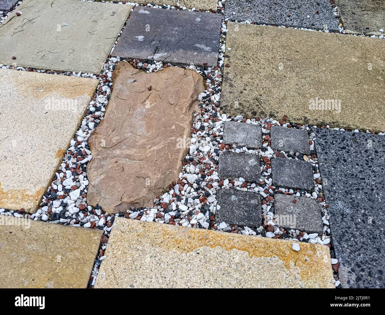 Flagstones and gravel on a very old patio Stock Photo - Alamy