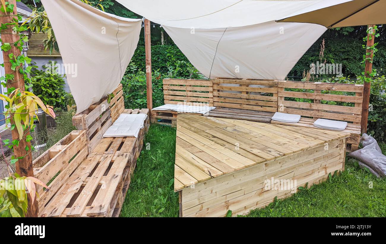 Patio table and benches made from pallets with a canvas roof Stock ...