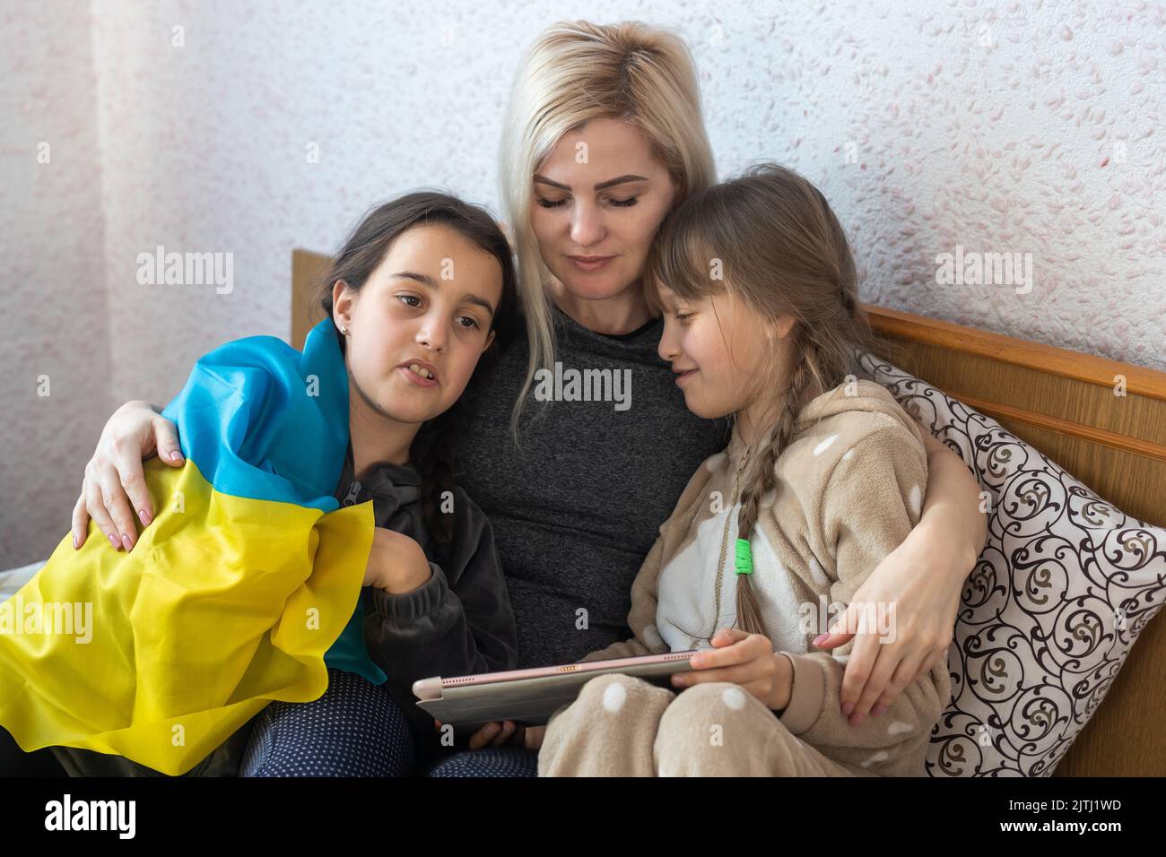 Families against war. mother and two daughters are reading with the ...