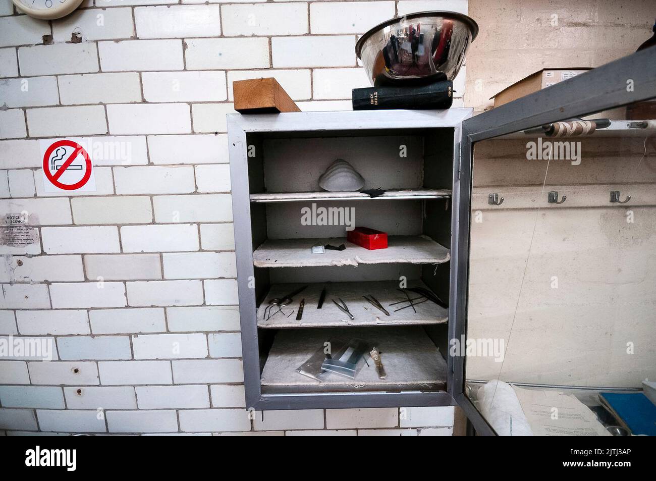 Cupboard containing surgical equipment in an abandoned mortuary morgue ...