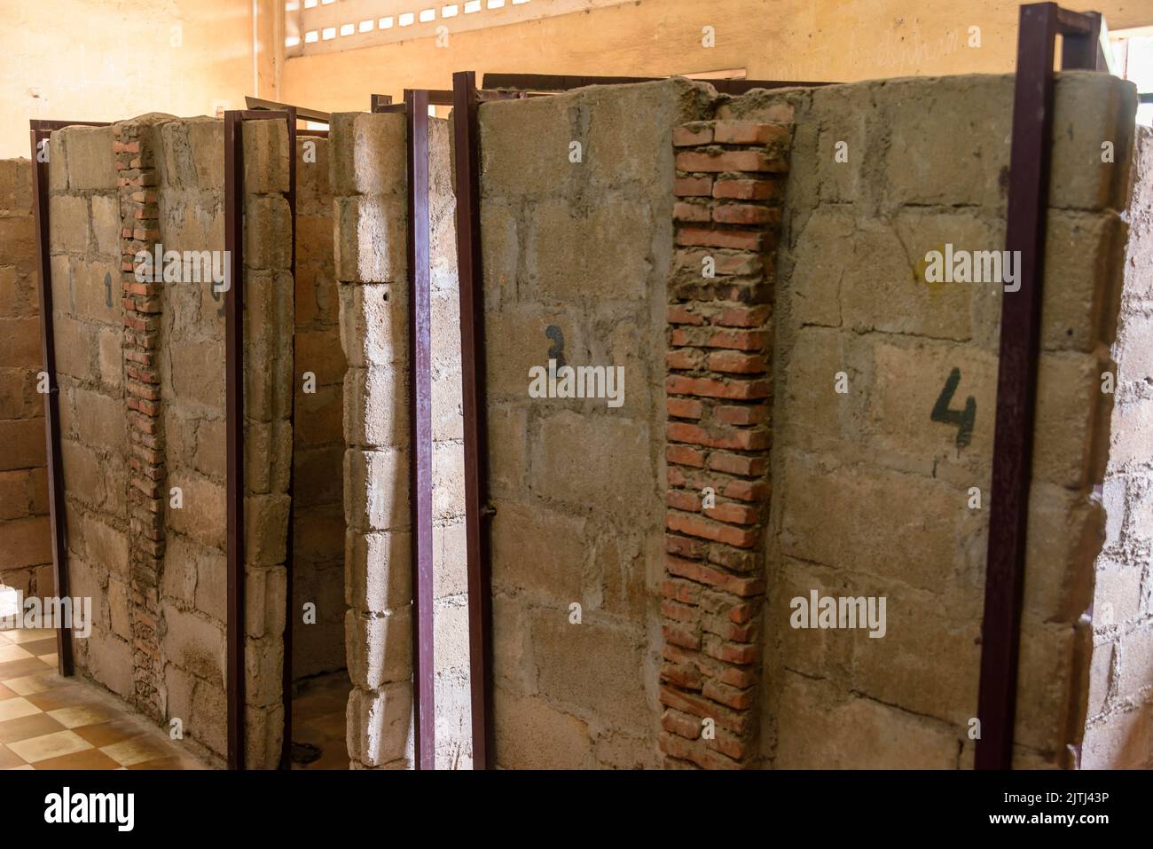 Cramped brick cells at the Tuol Sleng Genocide Museum, Phnom Penh ...