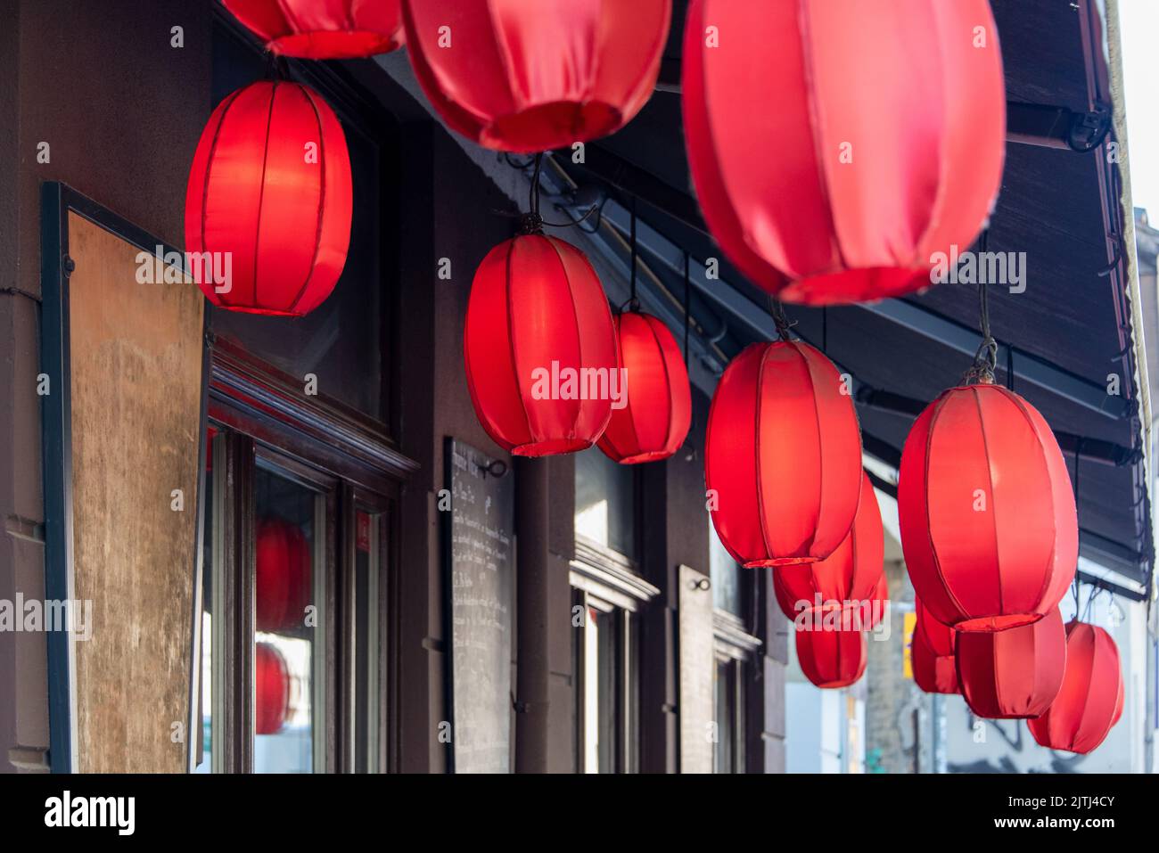 Red chinese lanterns hanging outdoors as a garland. Traditional asian ...