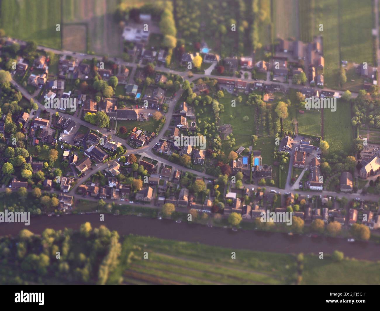 An aerial shot of country houses on a land by a river Stock Photo - Alamy