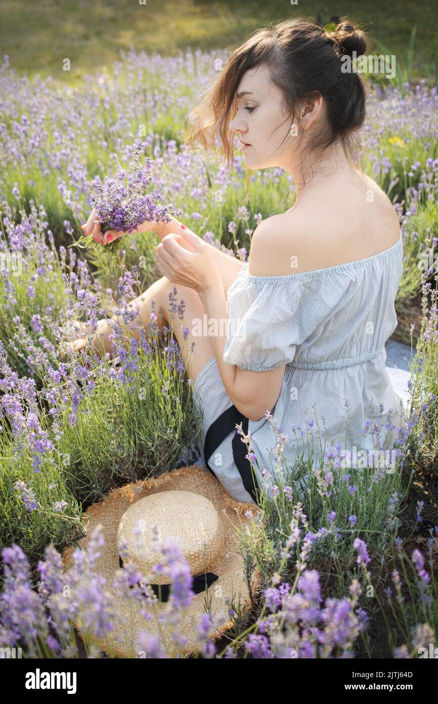 Beautiful young woman on lavender field. Sunset. Attractive young ...