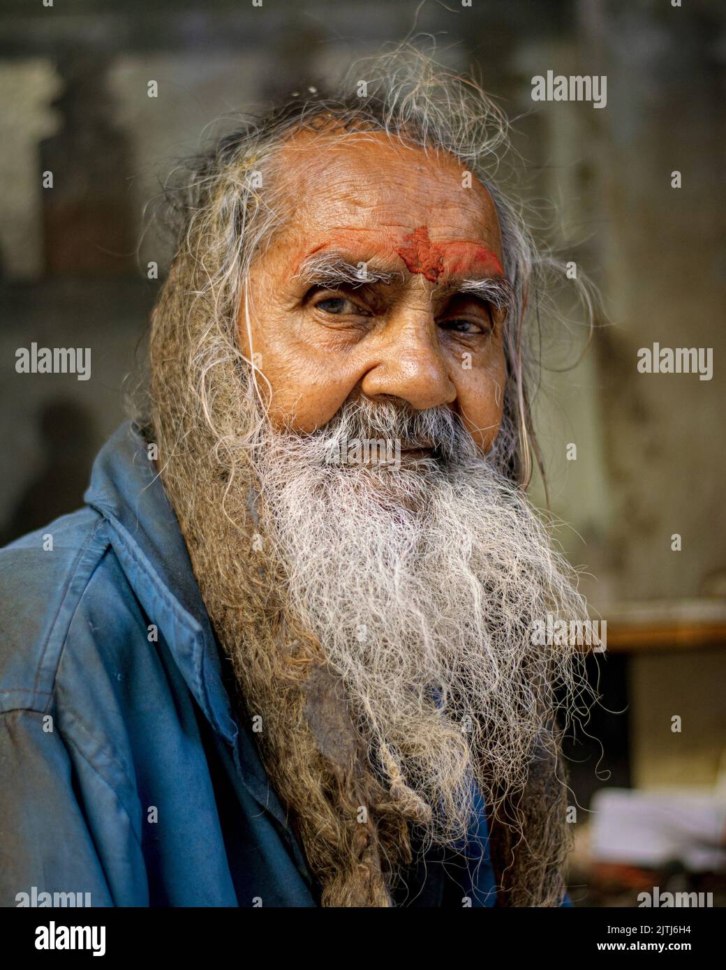 Elderly Indian man with long beard and messy hair, wearing dirty ...