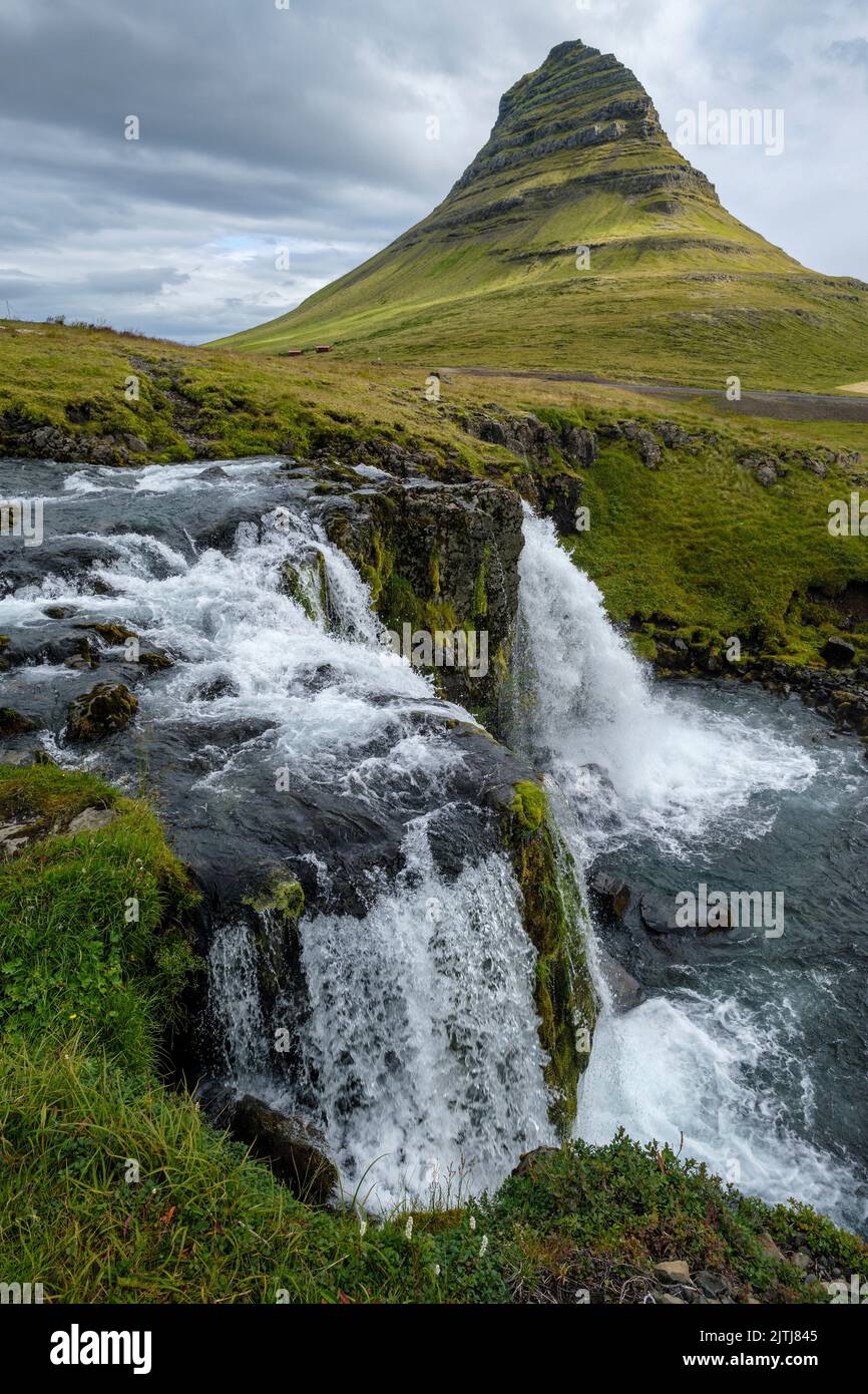Kirkjufell (Church Mountain) with the waterfall Kirkjufellsfoss in the ...