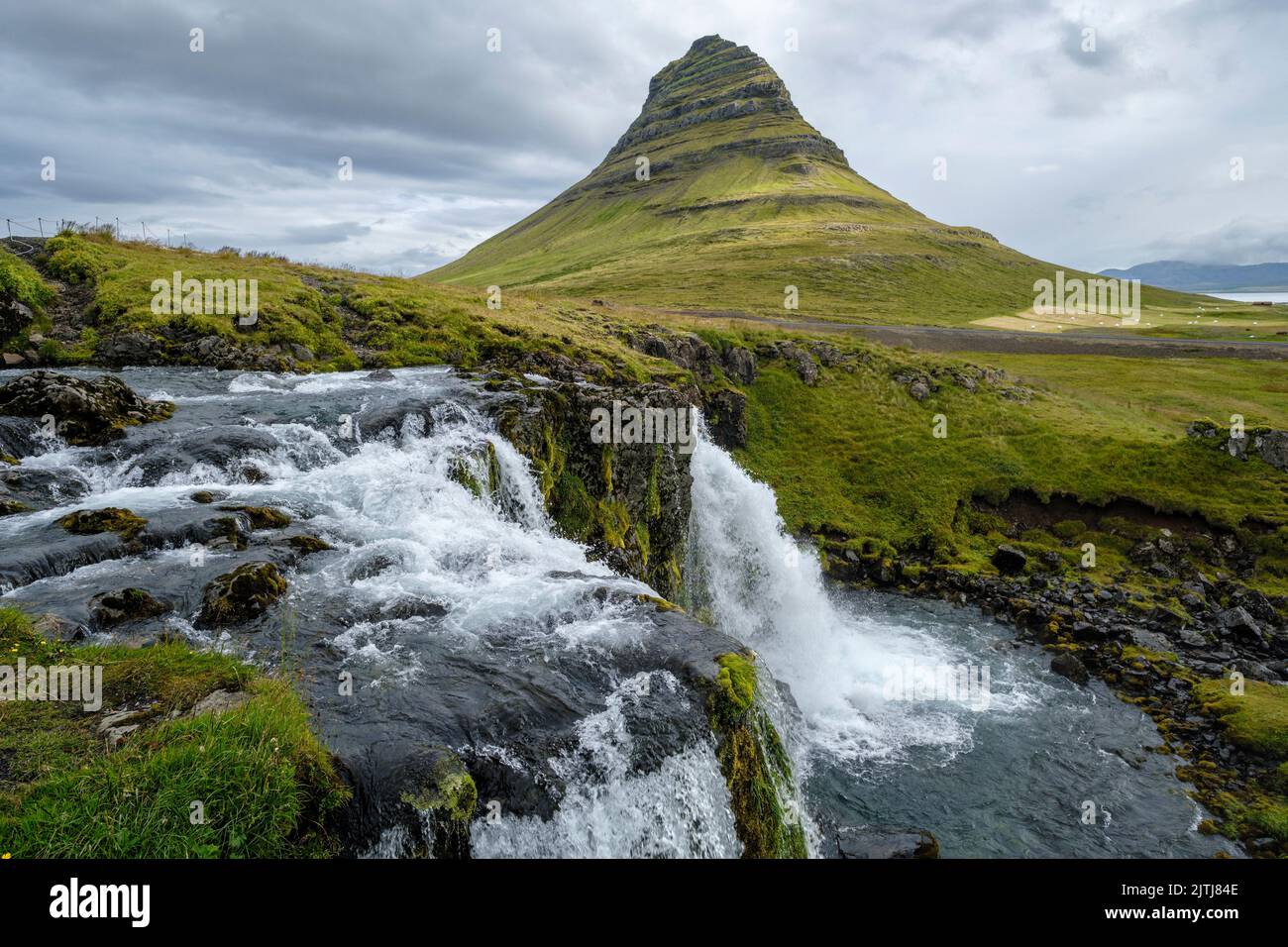 Kirkjufell (Church Mountain) with the waterfall Kirkjufellsfoss in the ...