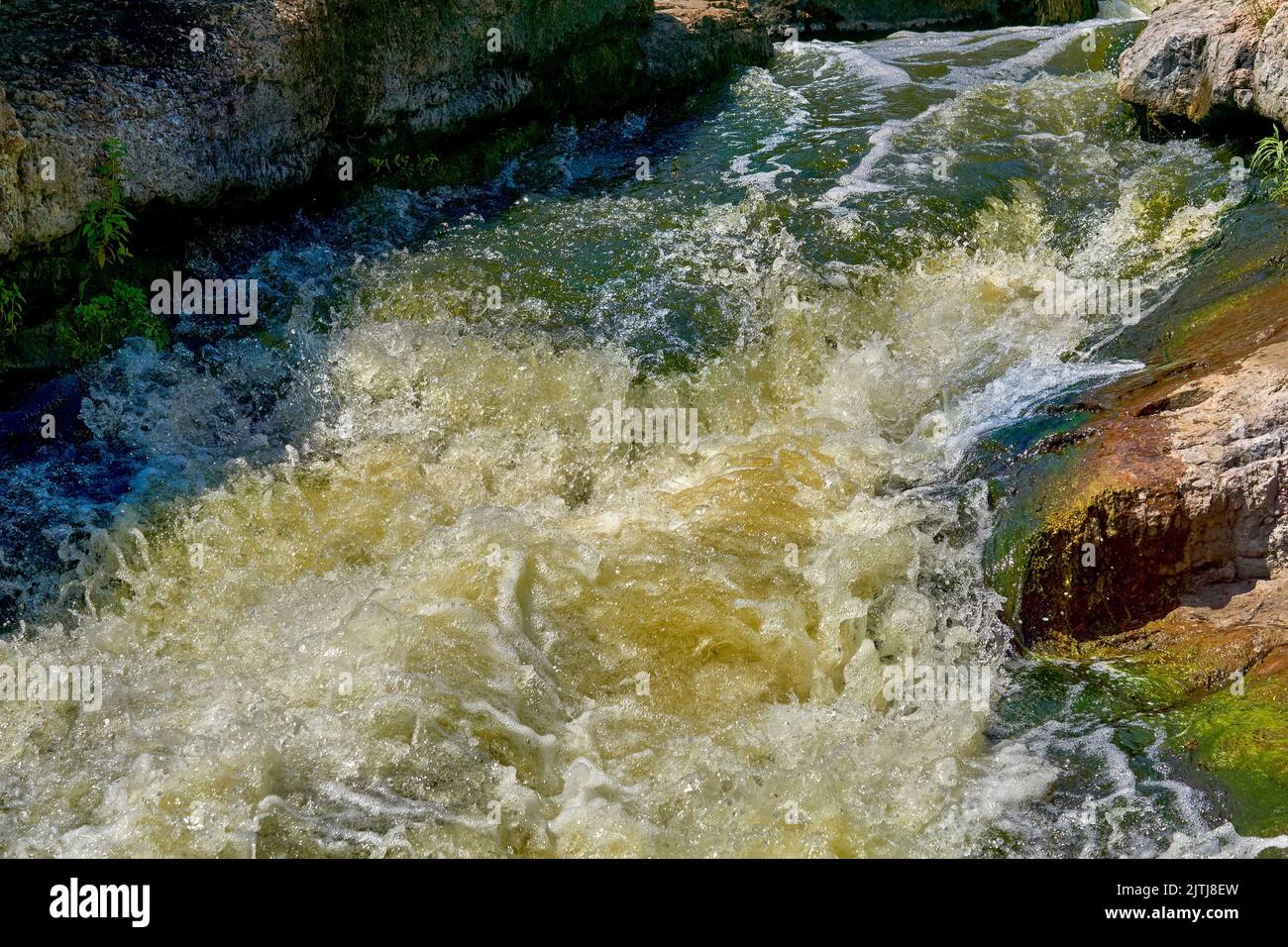 Stormy fast cleaner flow of a mountain river among a stone brown ...