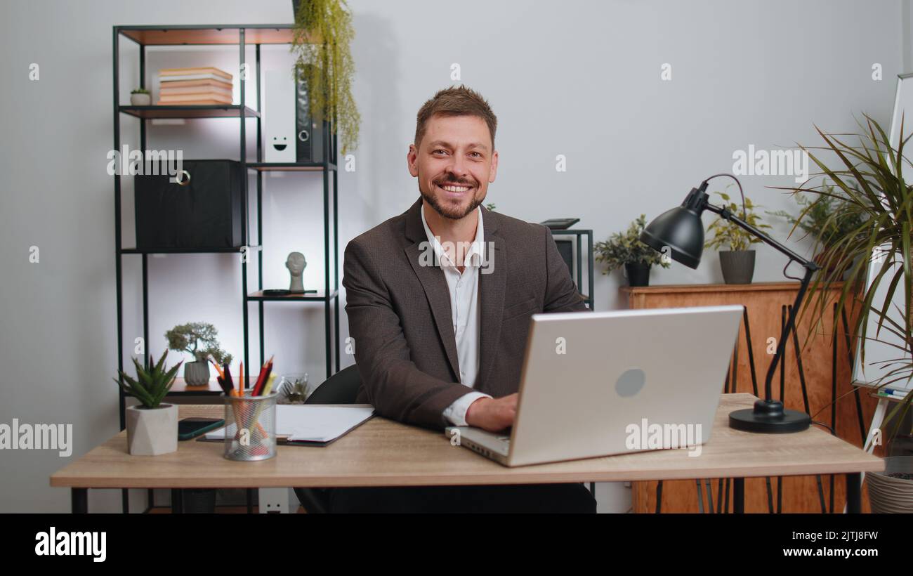 Businessman freelancer in suit enters office workplace, working on ...