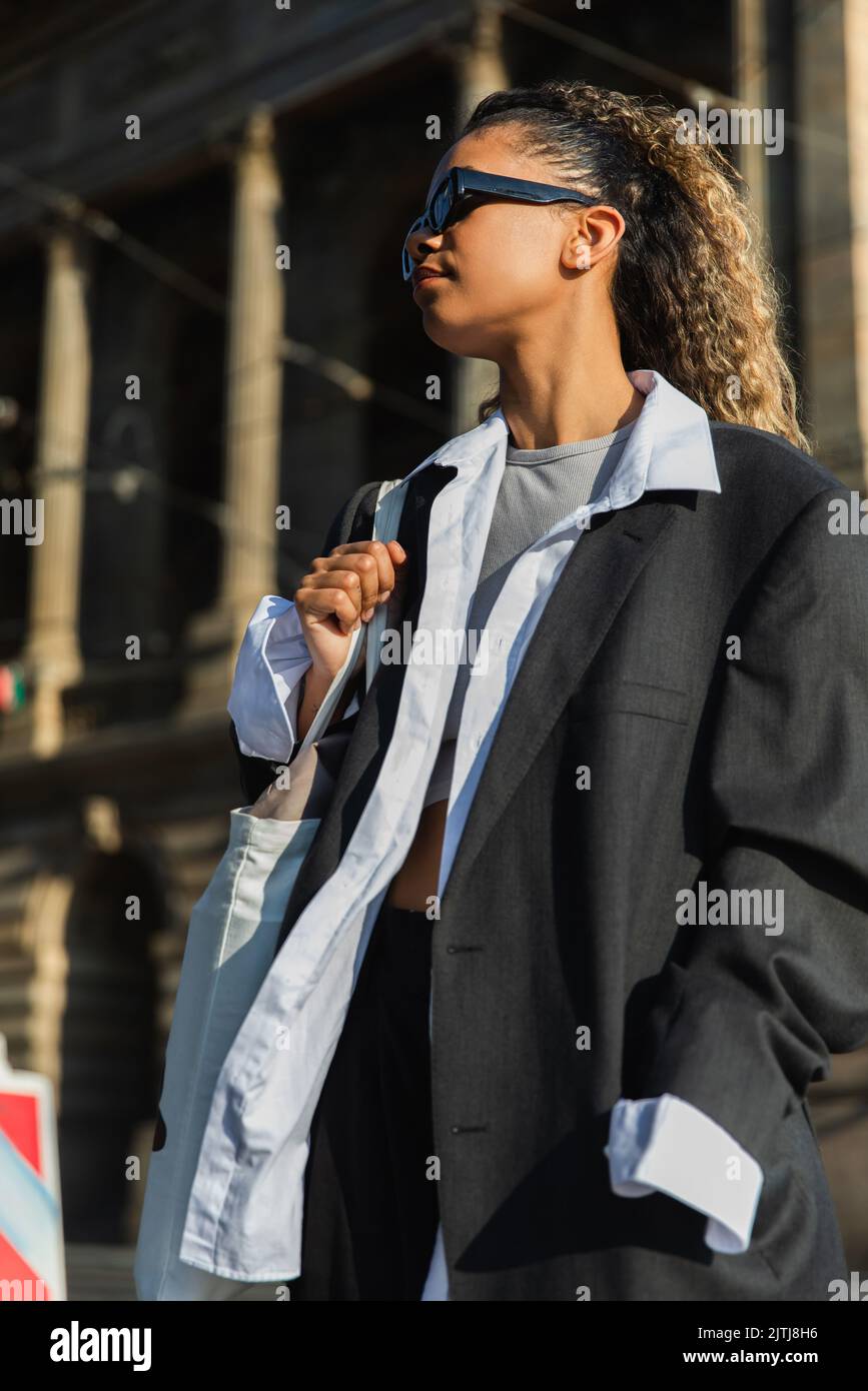 low angle view of young african american woman in sunglasses posing ...