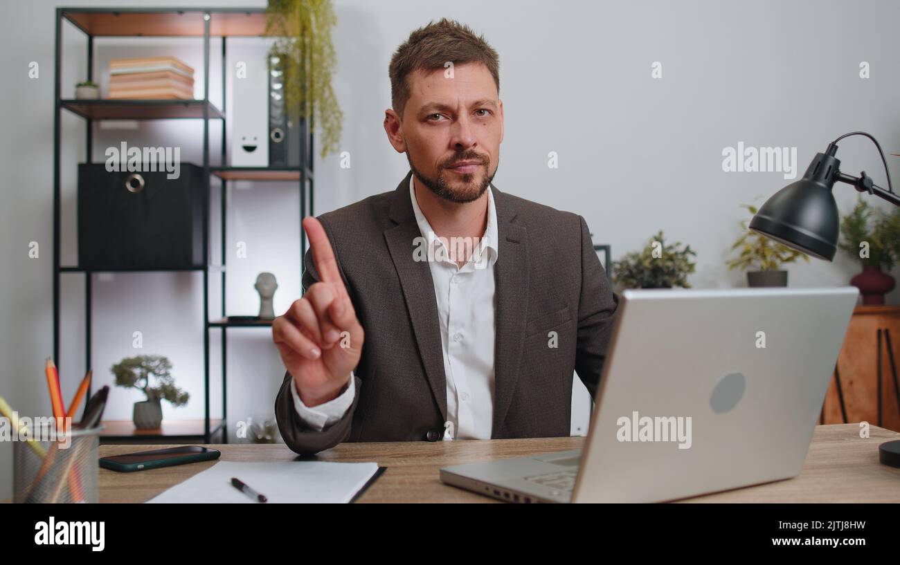 Serious businessman laptop saying no hi-res stock photography and ...