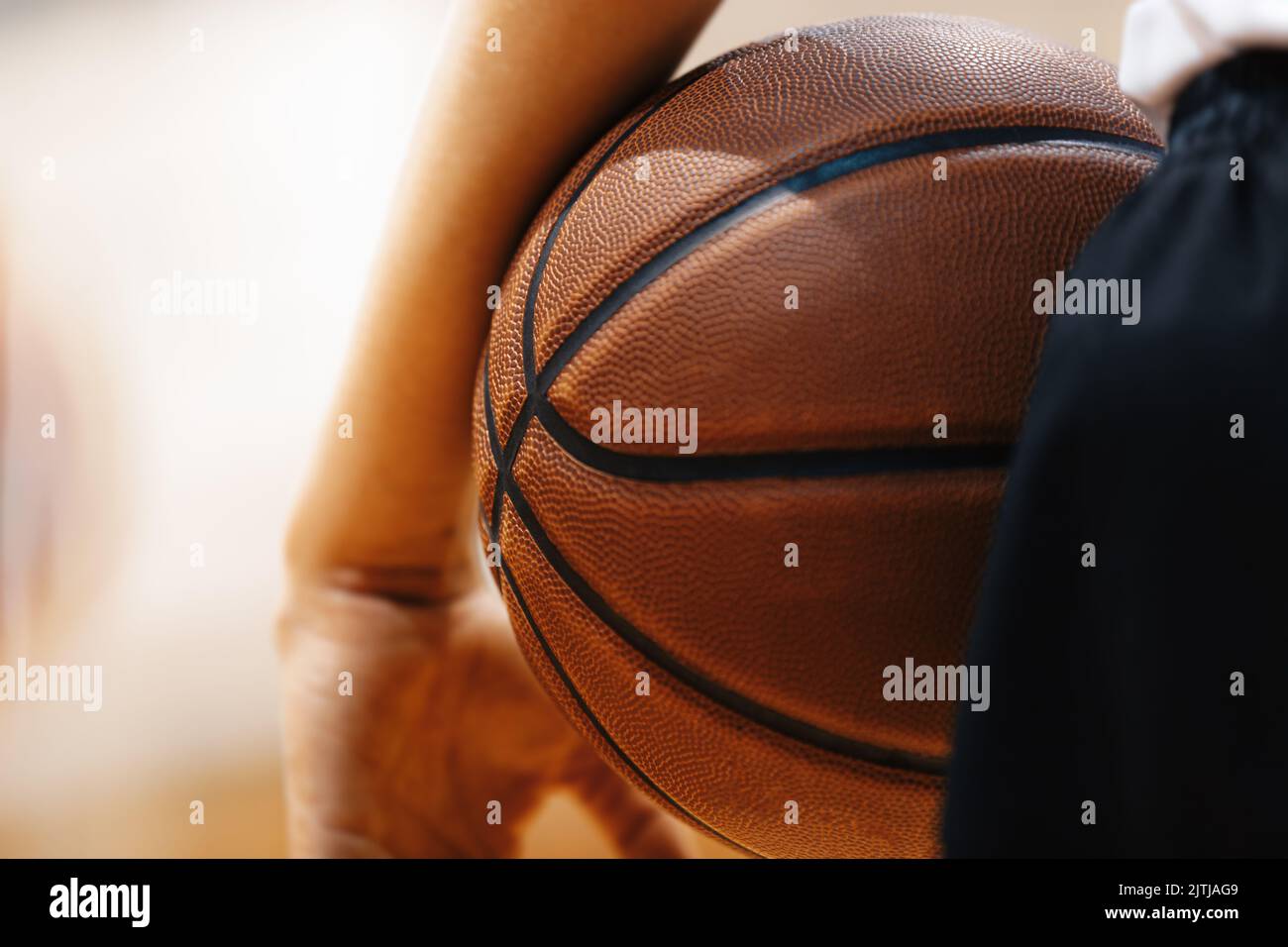 Adult basketball player holding game ball. Basketball training session ...