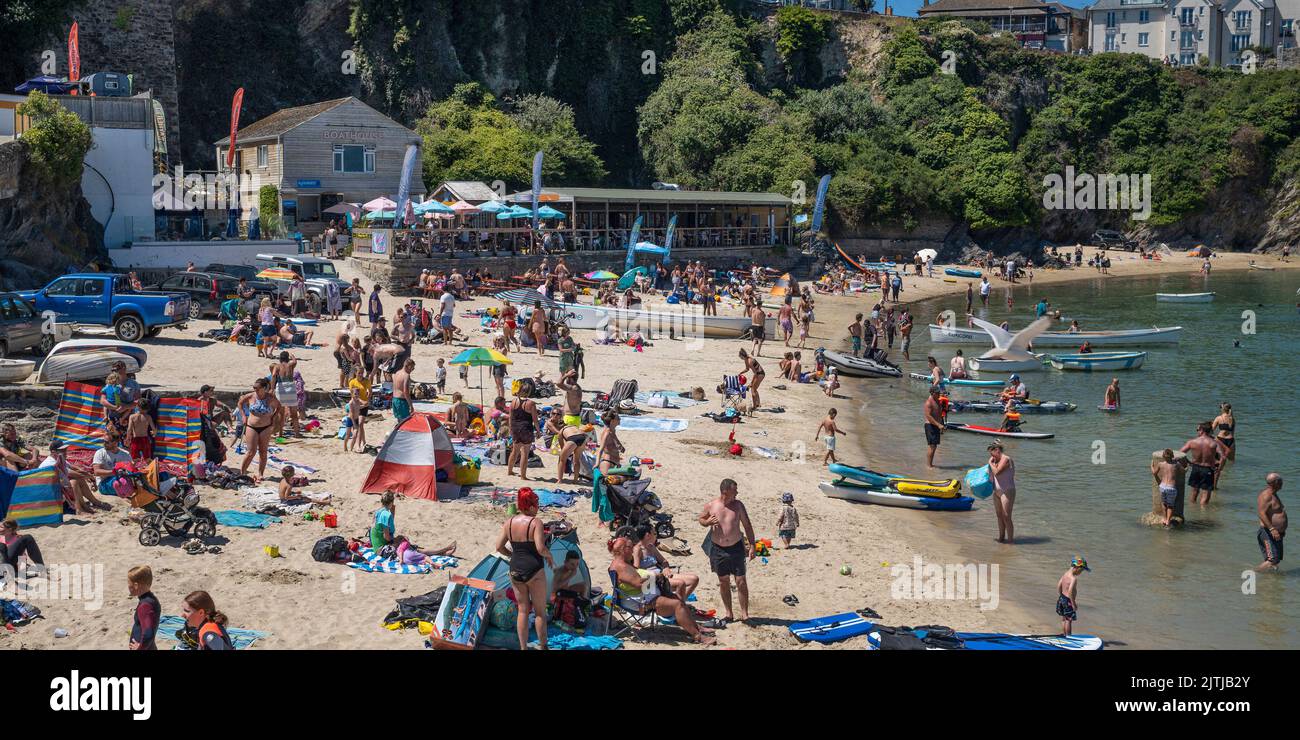 A panoramic image of holidaymakers crowded on the small beach in the ...