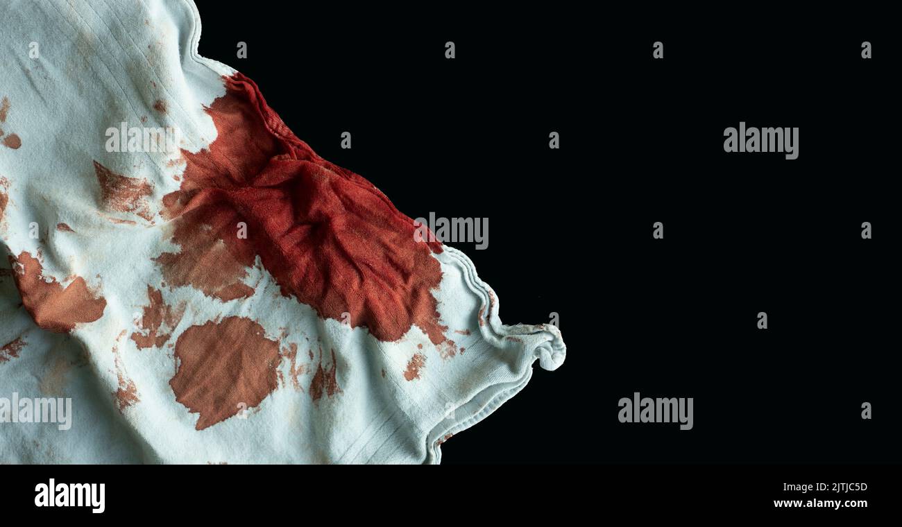White handkerchief covered in blood splatter. Isolated against a plain ...