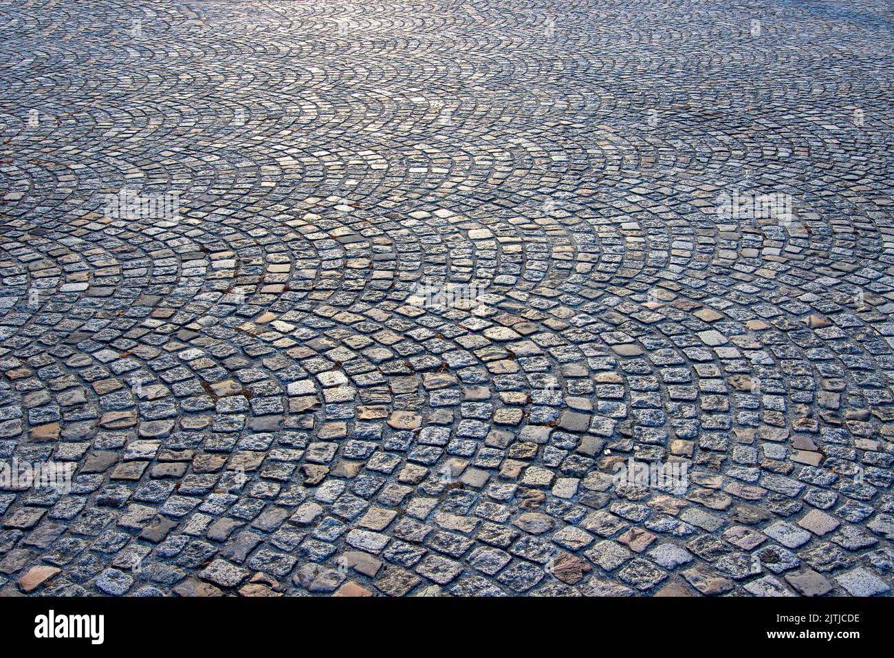 Cobbles in an arc pattern in a market square with golden light. High ...