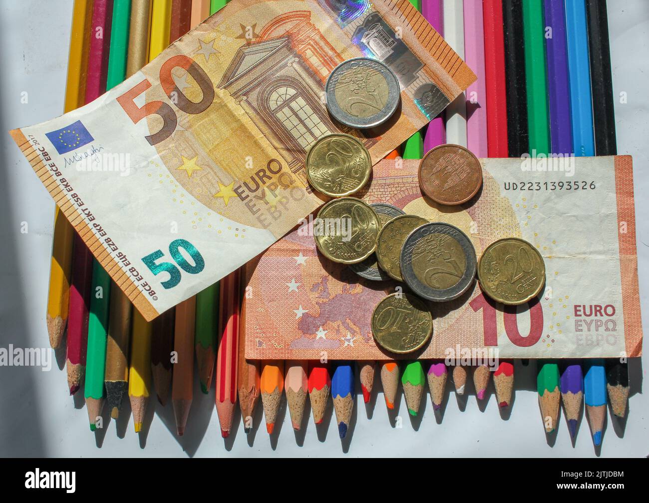 euro cash on some colored pencils before going back to school Stock ...