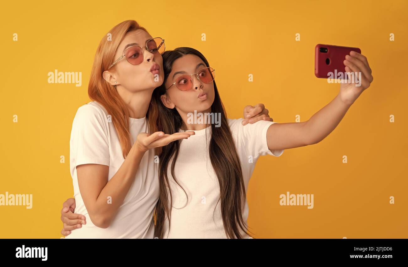 happy woman and girl take selfie with smartphone. selfie family. modern ...