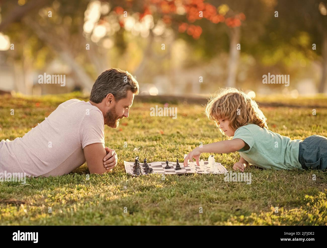 strategic and tactic. tutorship. dad and kid play logic game. father ...
