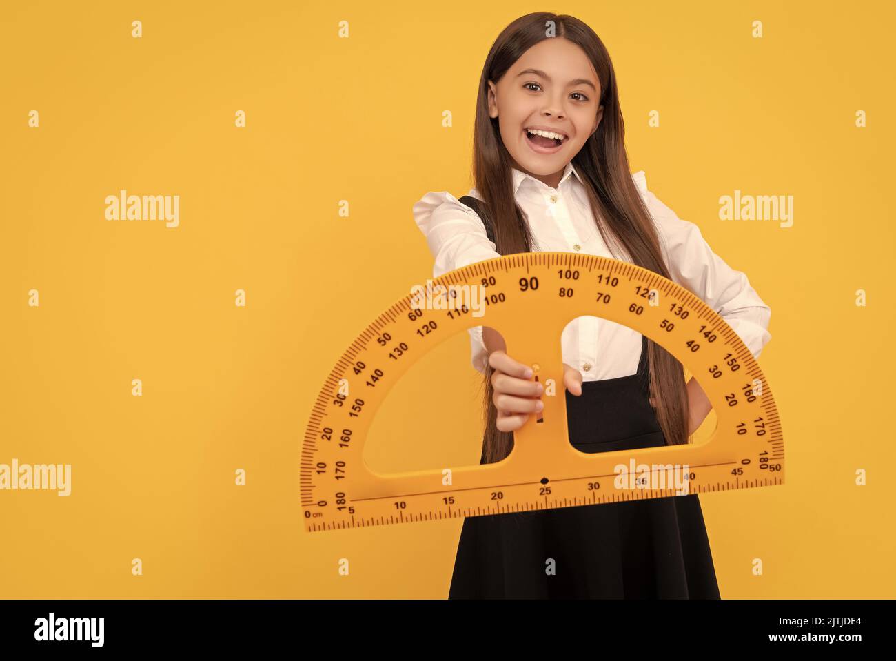 amazed kid in school uniform hold mathematics protractor for measuring ...