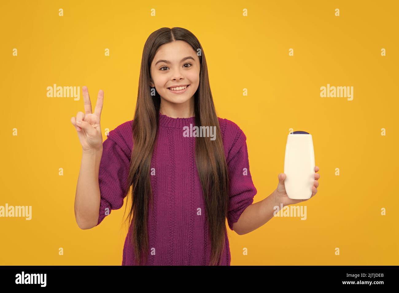 Child teen girl with shampoos conditioners and shower gel. Long hair ...