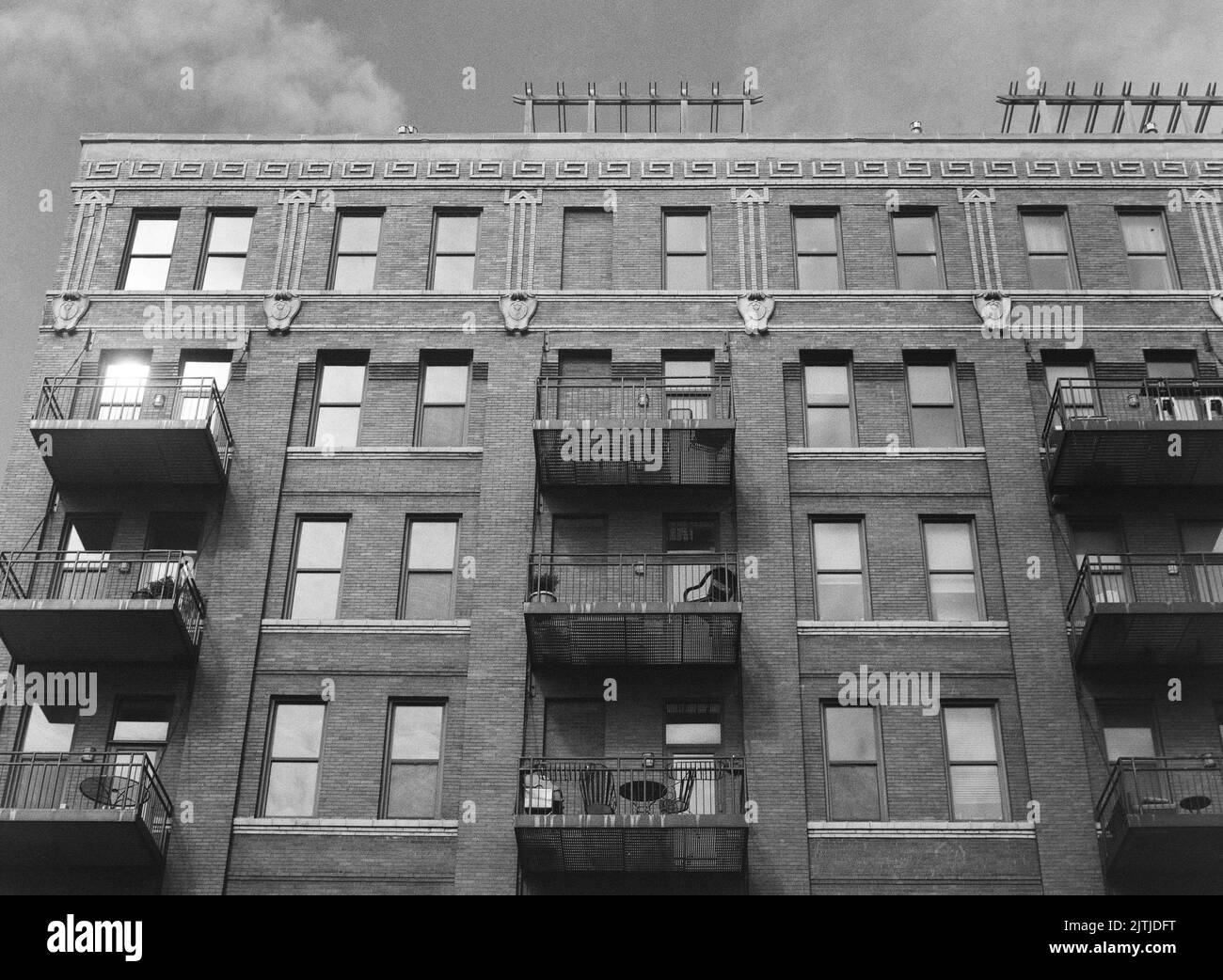 A grayscale shot of the facade of a stone residential building Stock ...