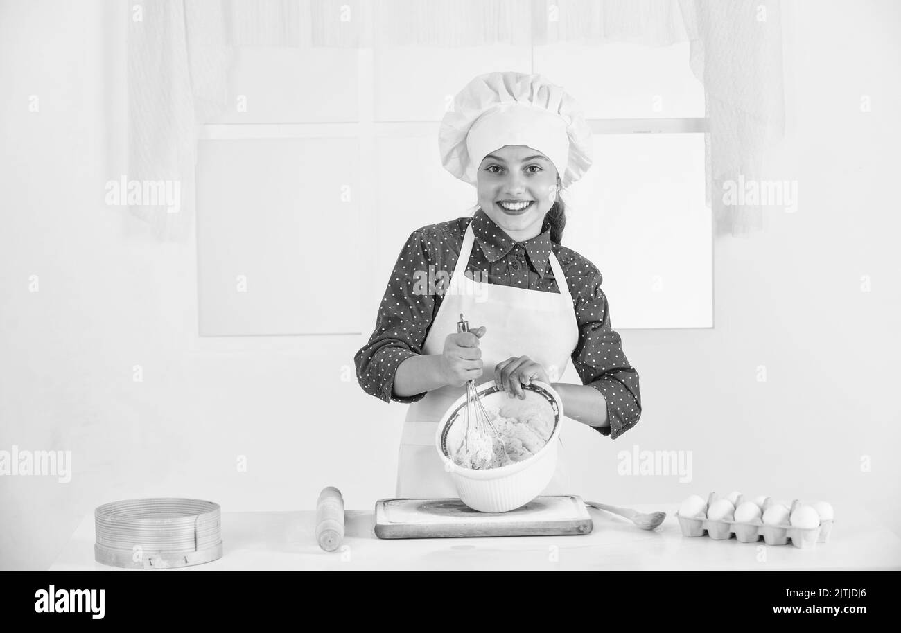 Taste meets excellence. happy childhood. happy teen girl cooking dough ...