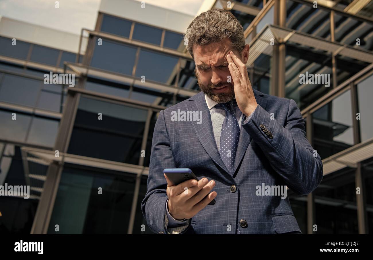 mobile connection technology. frustrated businessman hold smartphone ...