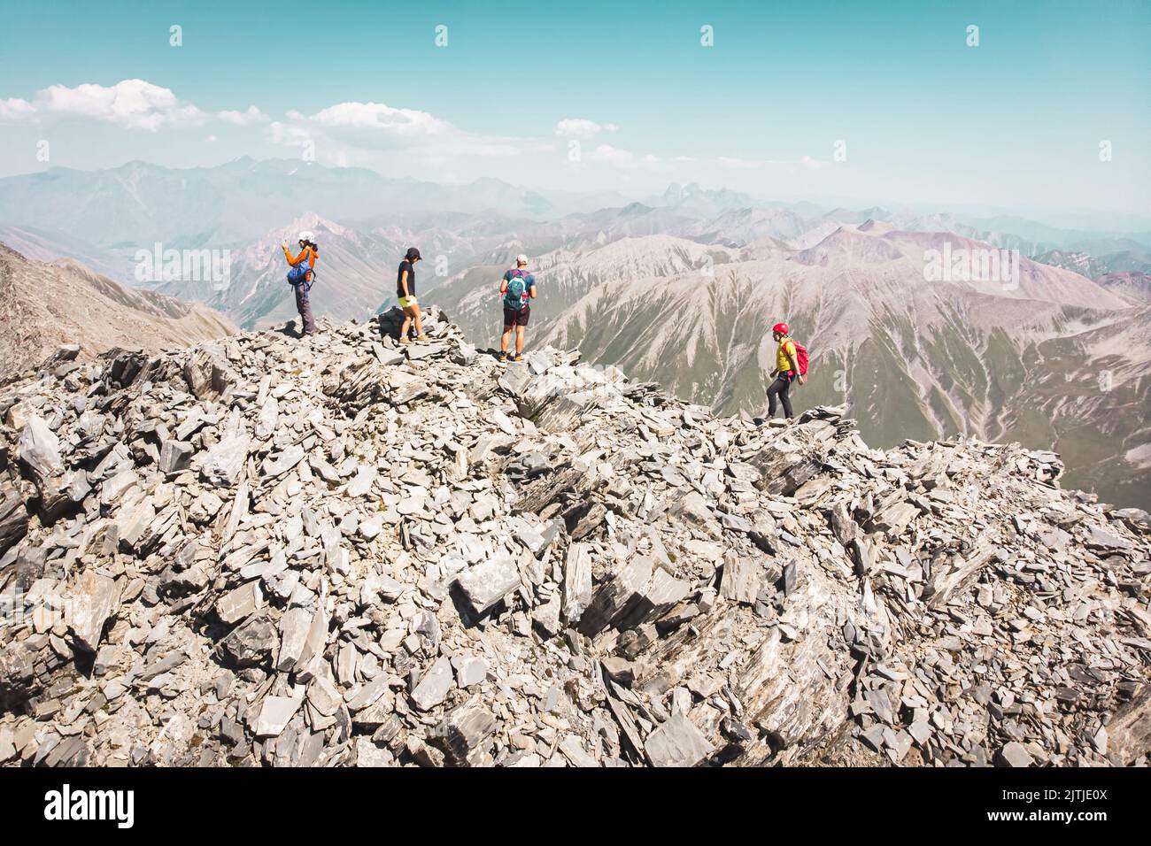 Aerial top view Hikers couples hug after reaching top together on Deda ...