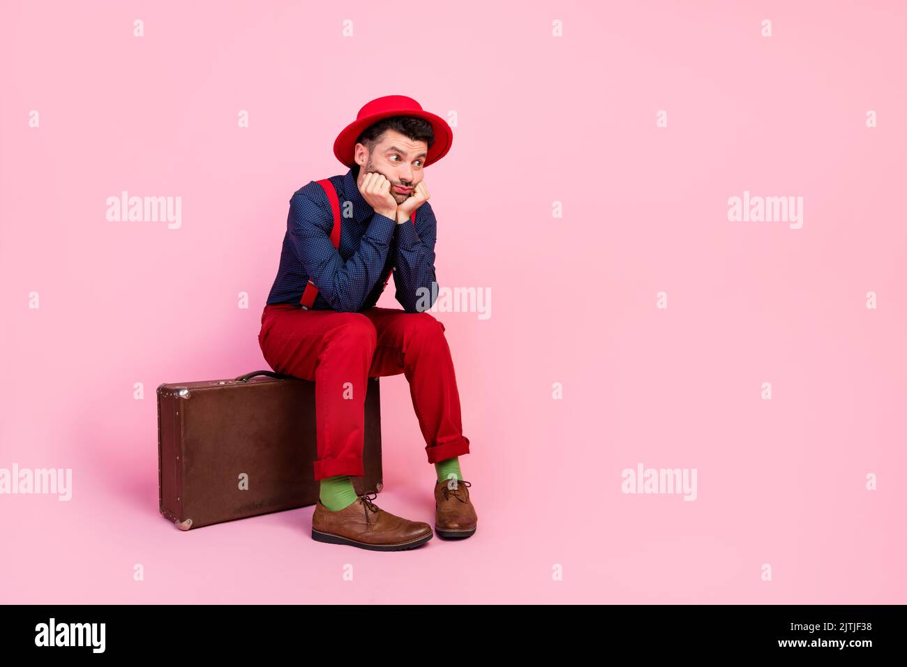 Full body size photo of young attractive handsome man sitting suitcase ...
