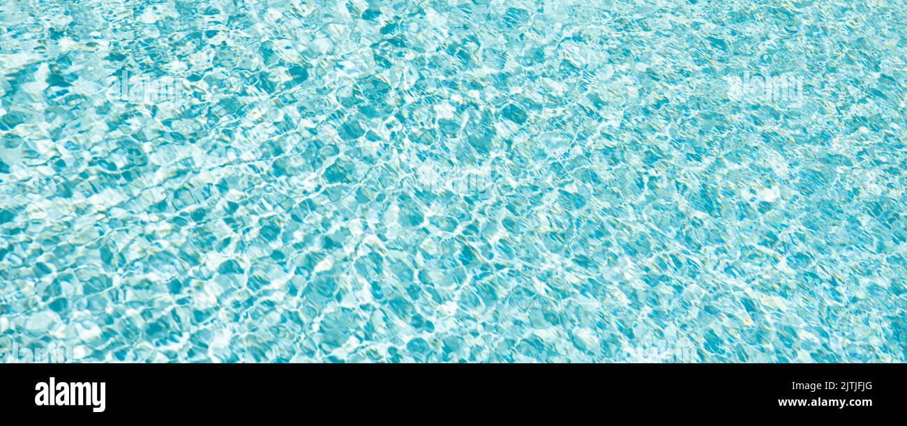 turquoise color background of swimming pool water with ripples in ...