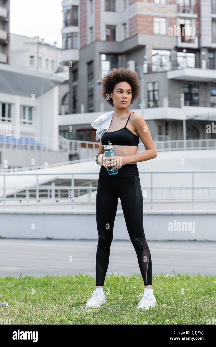 full length of slim african american woman in sportswear standing on ...