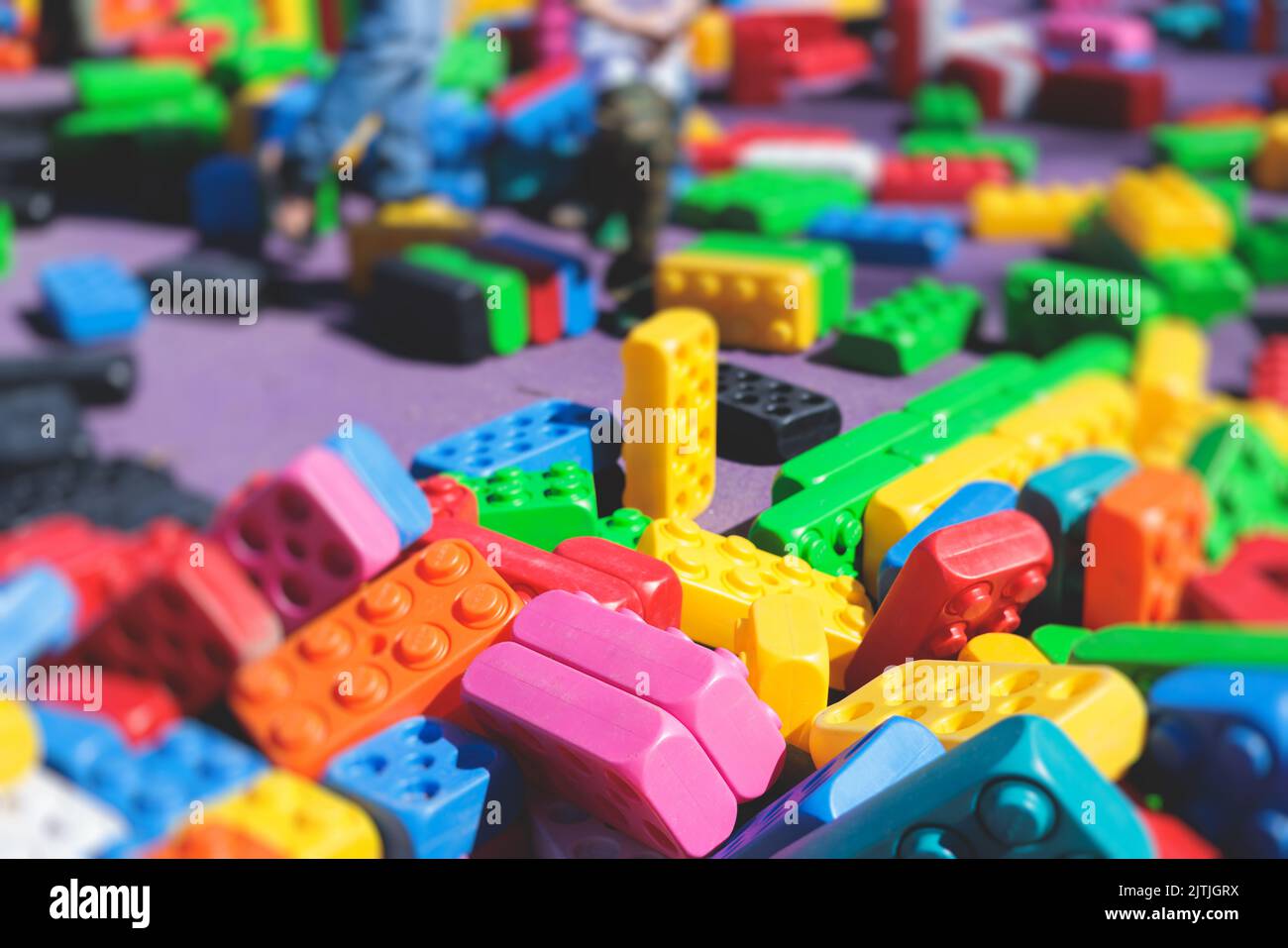 Children play colorful big toy blocks in kindergarten day care center ...