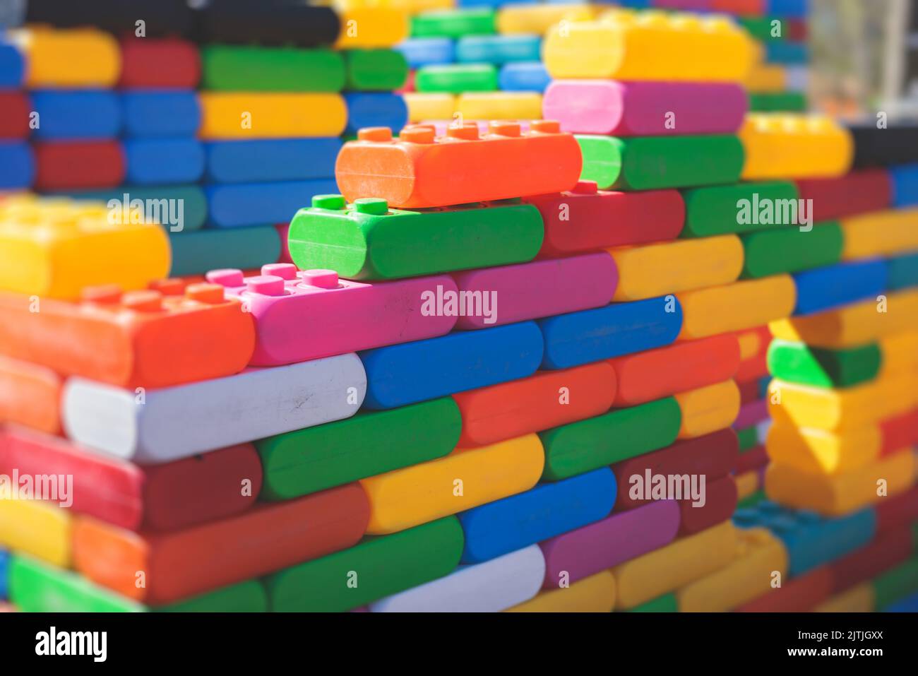 Children play colorful big toy blocks in kindergarten day care center ...