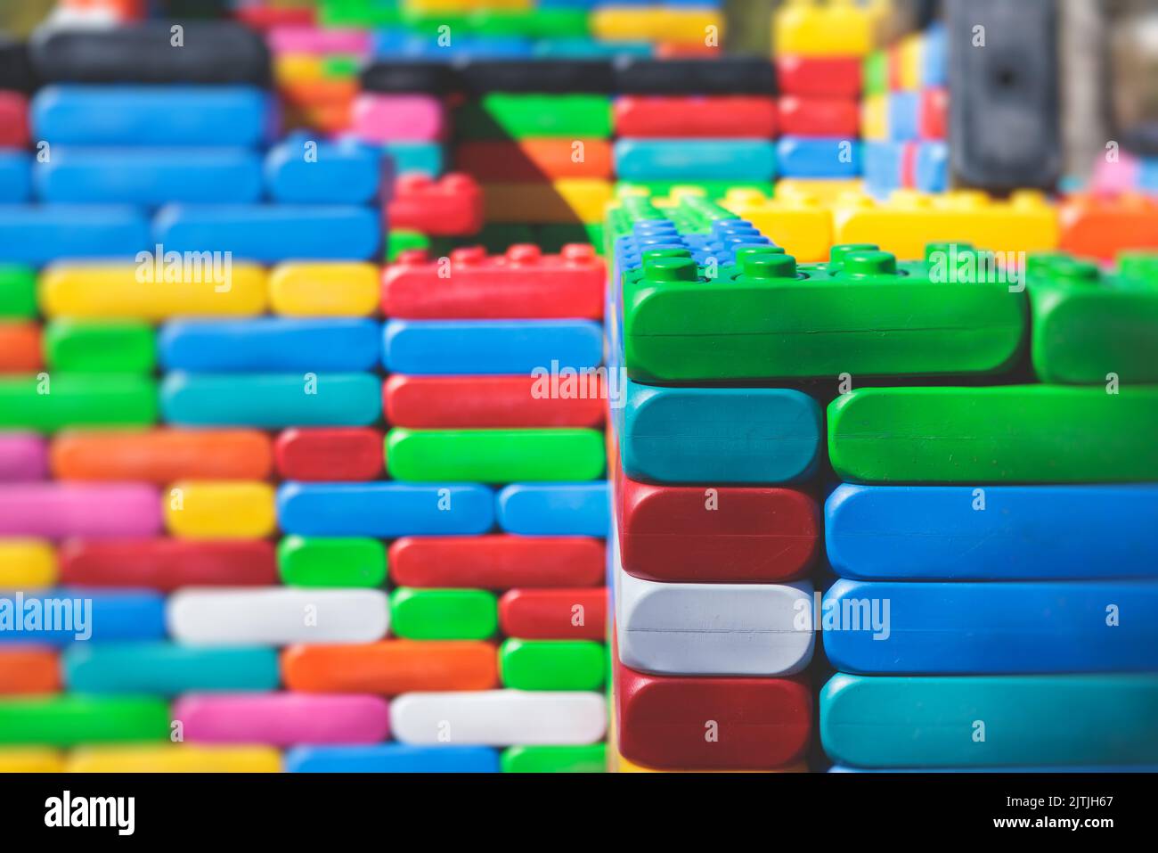 Children play colorful big toy blocks in kindergarten day care center ...