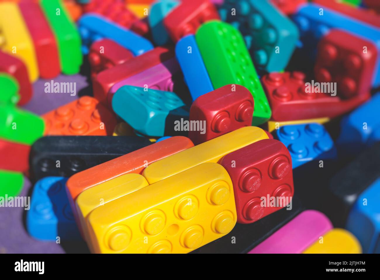 Children play colorful big toy blocks in kindergarten day care center ...