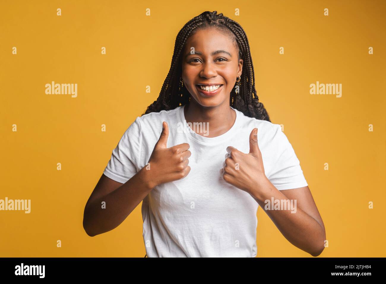 Pleased woman with cool hairstyle smiling at camera and gesturing ...