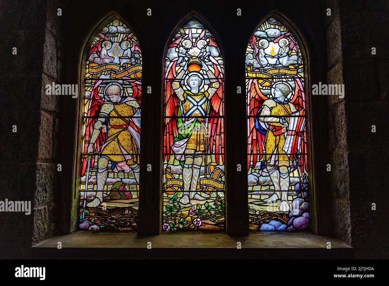 Colorful stained glass windows featuring scripture and knights in ...