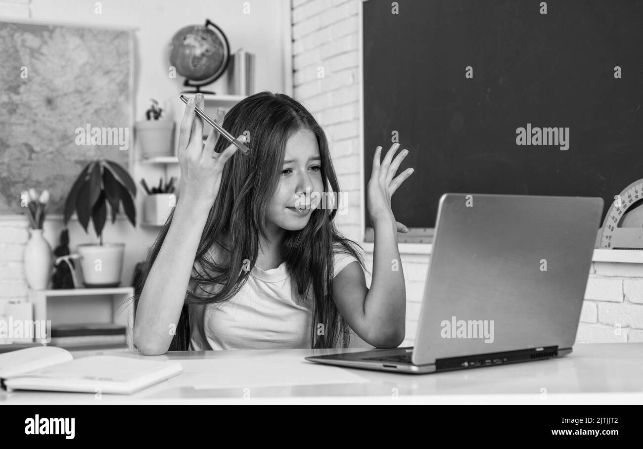 knowledge day. child pupil sit at table and use computer. girl is college student. back to ...