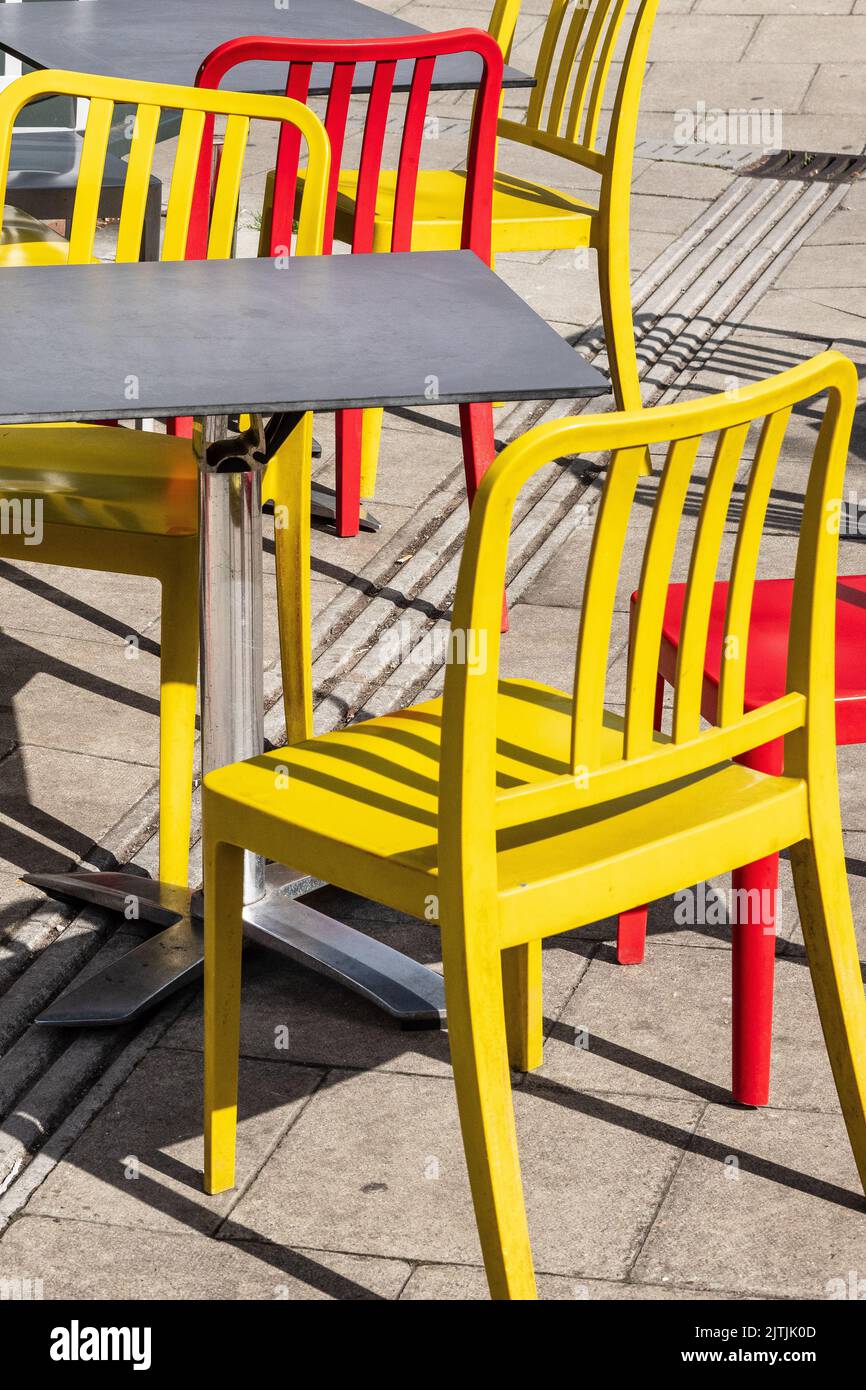 Abstract of colourful empty chairs outside a Welsh pavement cafe Stock ...