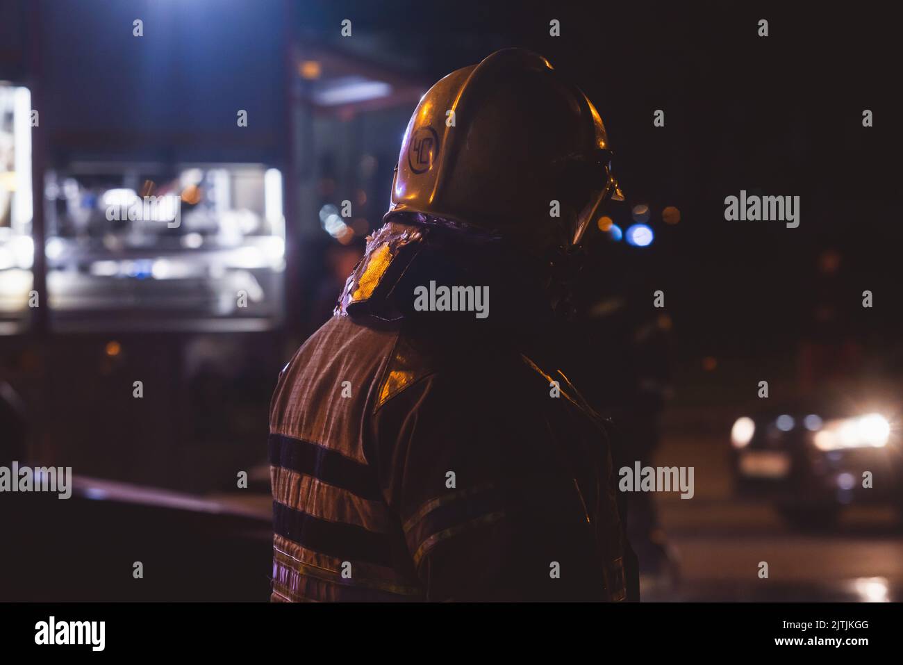 Group of fire men in uniform during fire fighting operation in the ...