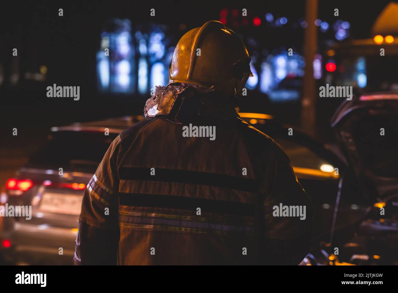 Group of fire men in uniform during fire fighting operation in the ...