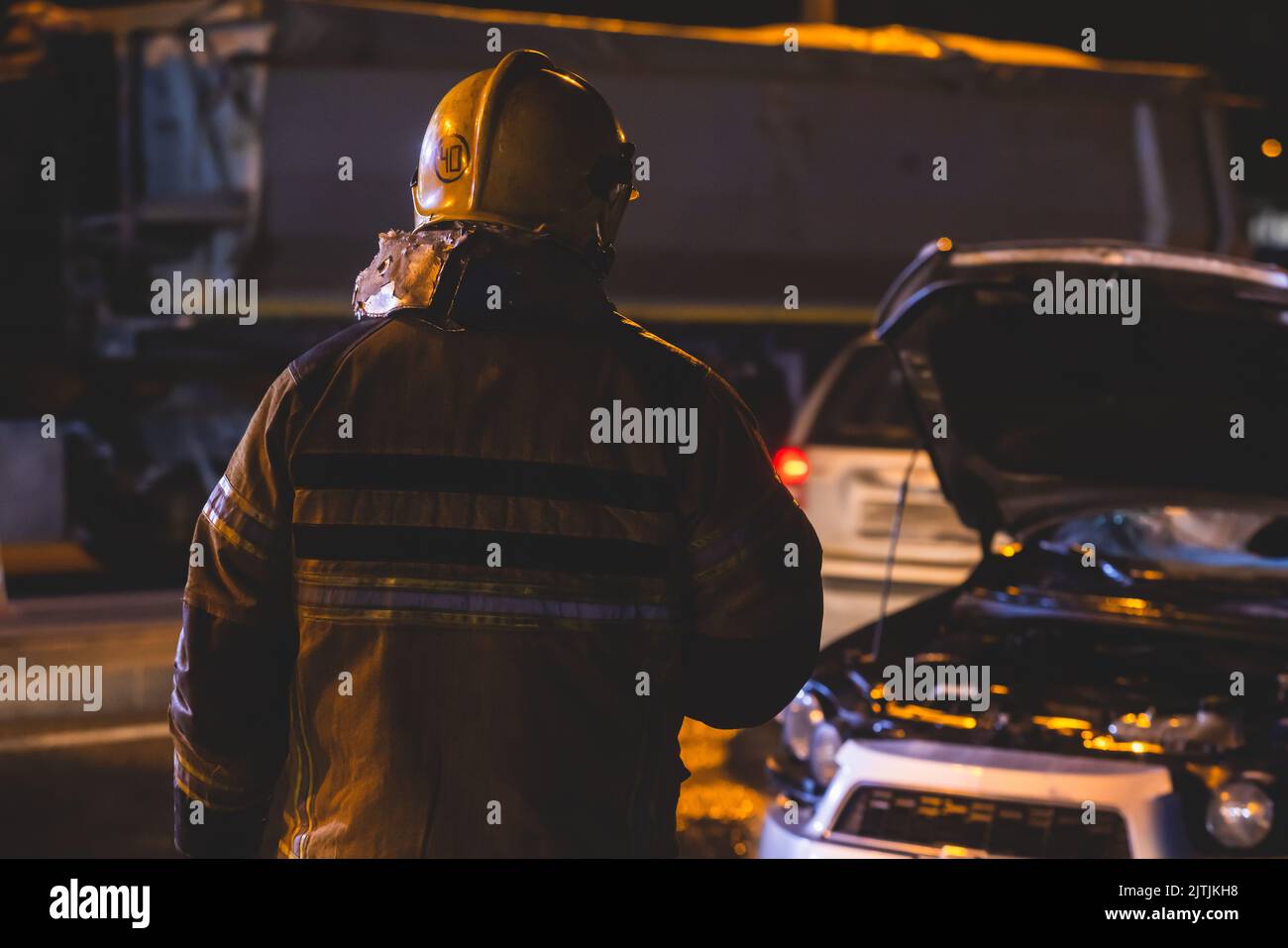 Group of fire men in uniform during fire fighting operation in the ...