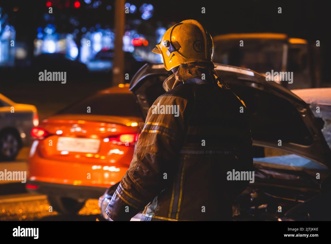 Group of fire men in uniform during fire fighting operation in the ...