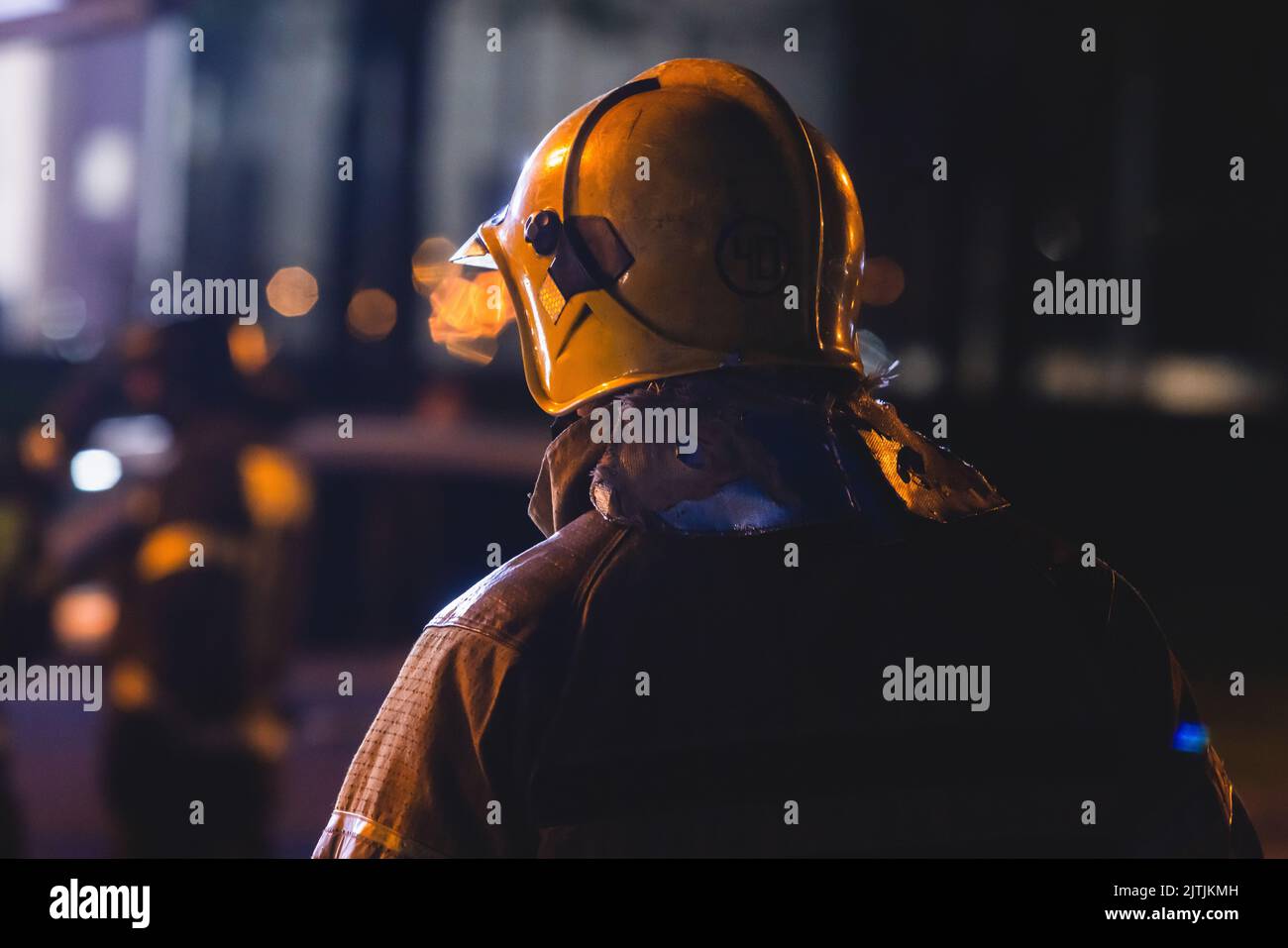 Group of fire men in uniform during fire fighting operation in the ...