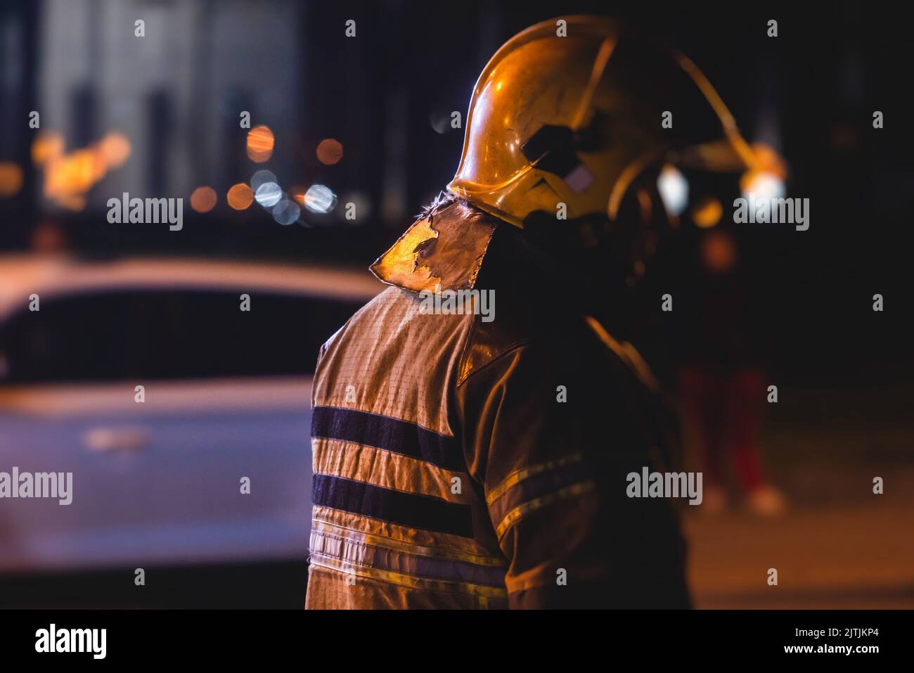 Group of fire men in uniform during fire fighting operation in the ...