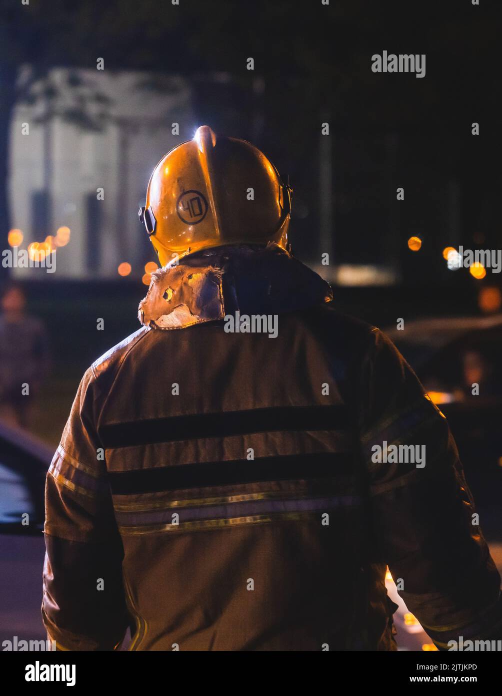 Group of fire men in uniform during fire fighting operation in the ...