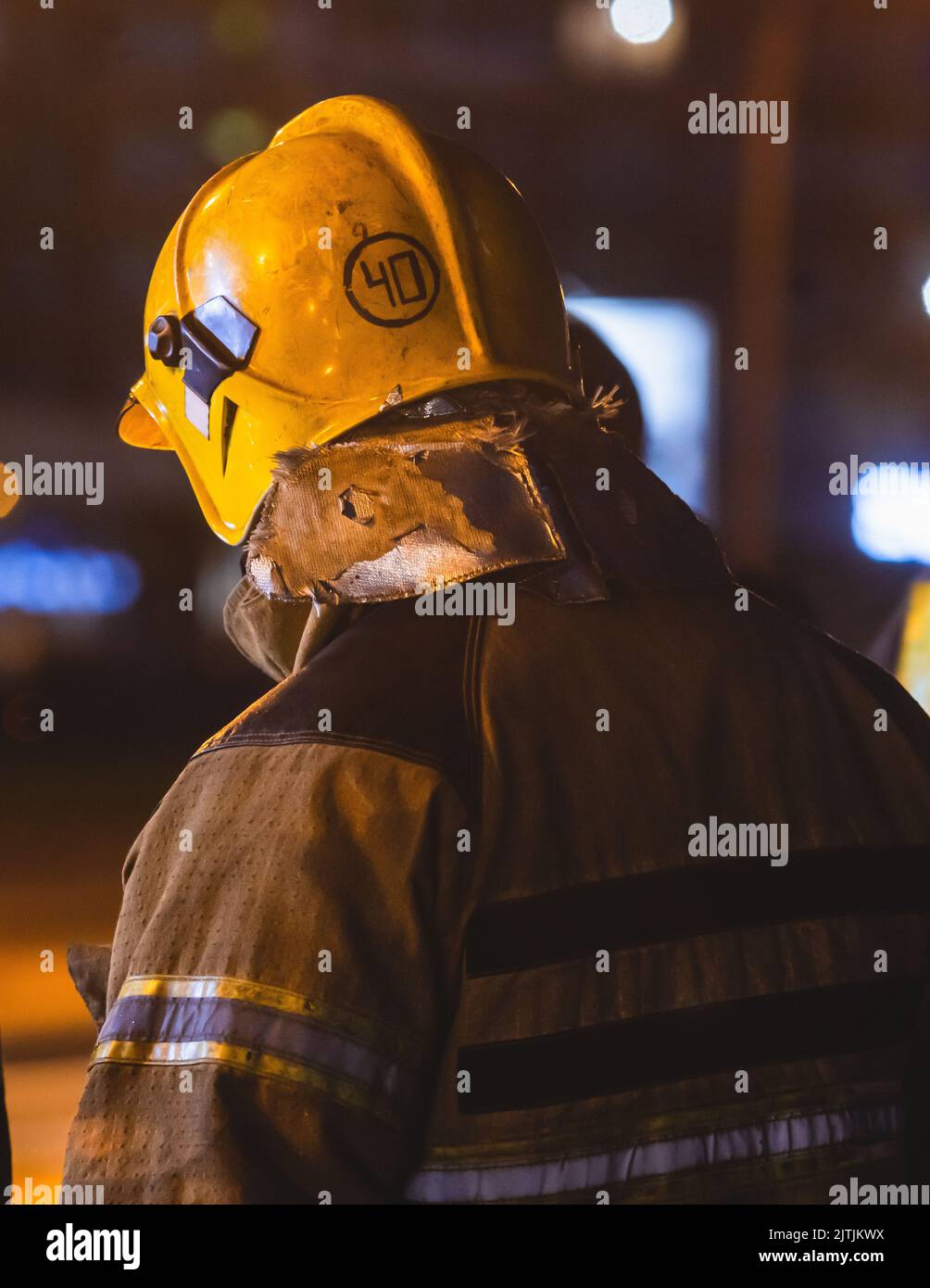 Group of fire men in uniform during fire fighting operation in the ...