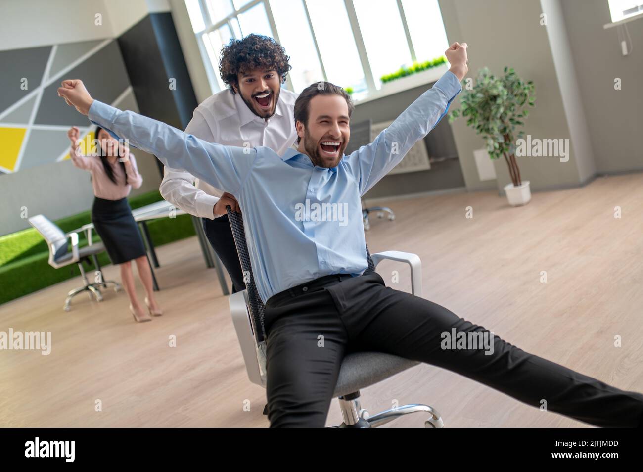 Young colleagues having fun in the office after work Stock Photo - Alamy