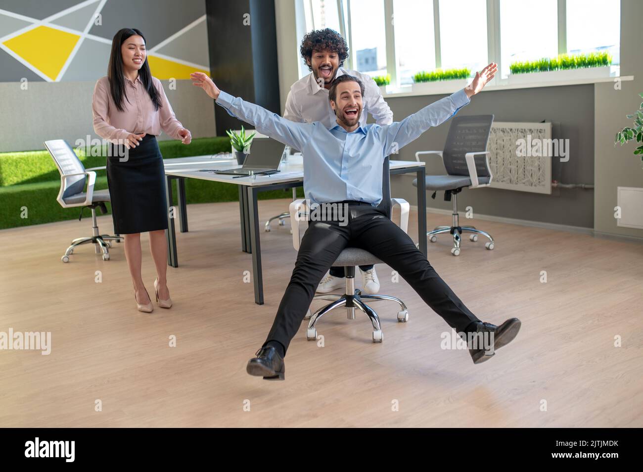 Young colleagues having fun in the office after work Stock Photo - Alamy