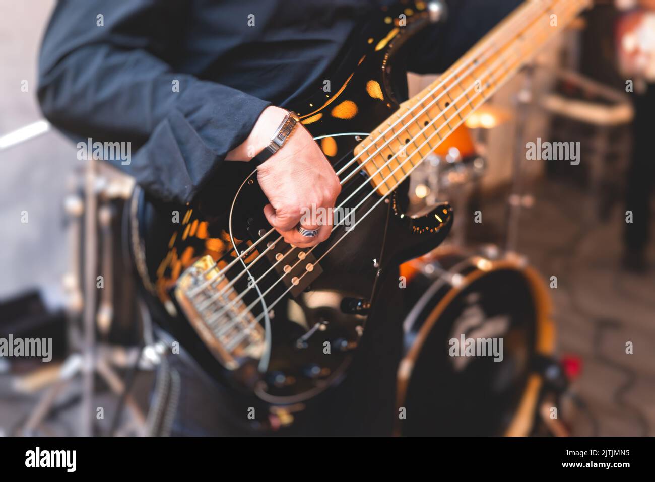 Concert view of musician, electric bass guitar player with during band ...